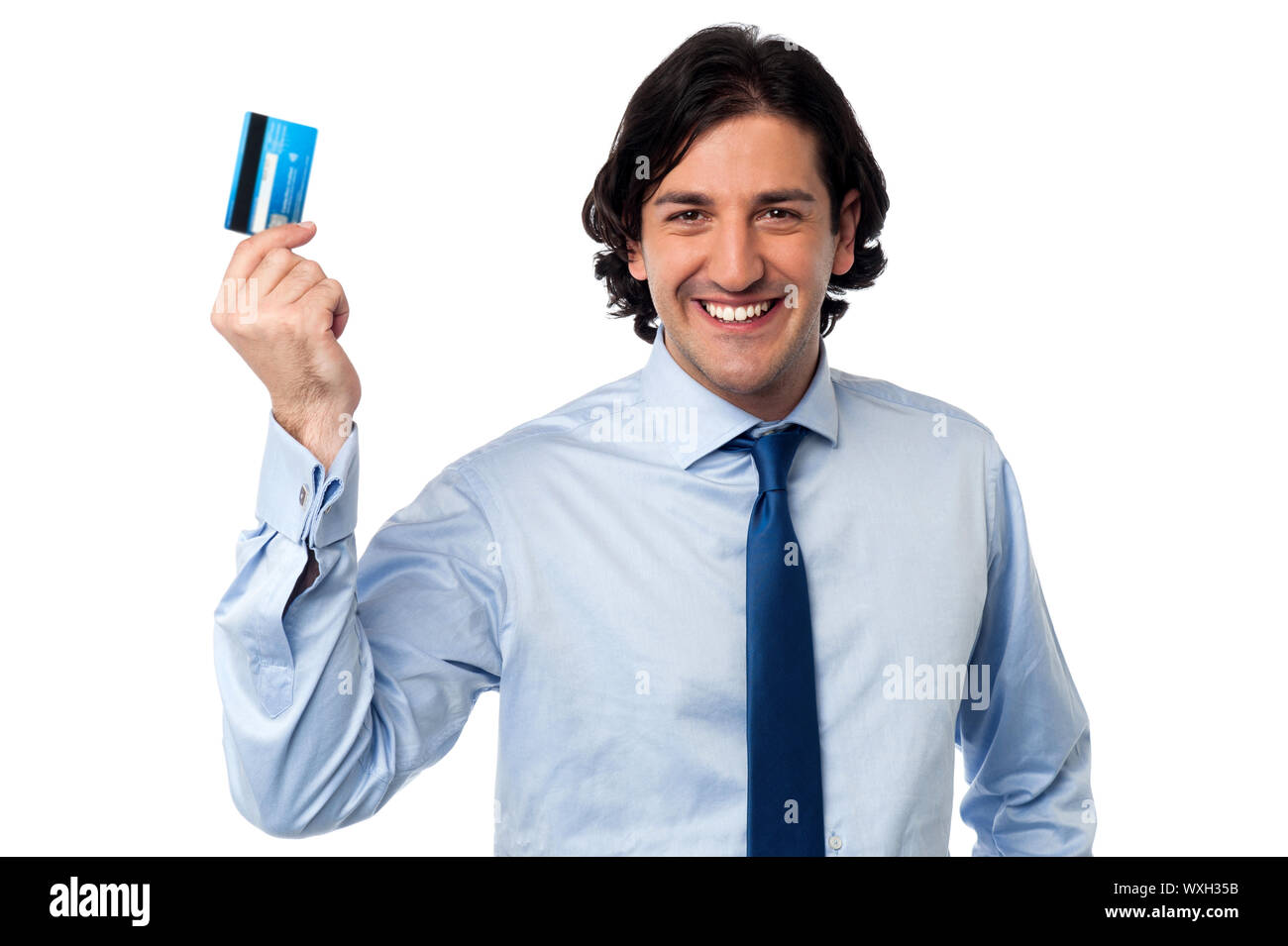 Smiling young corporate man holding up his credit card Stock Photo - Alamy