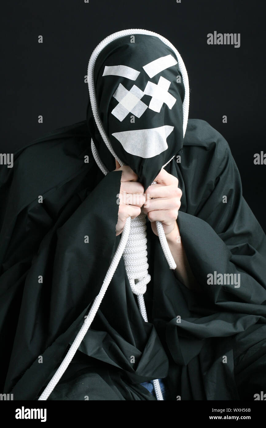 Black mime with rope on neck on black background Stock Photo - Alamy