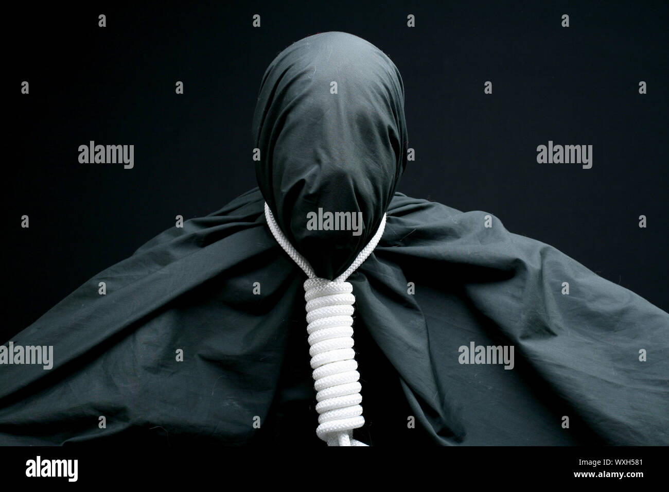 Black mime with rope on neck on black background Stock Photo - Alamy