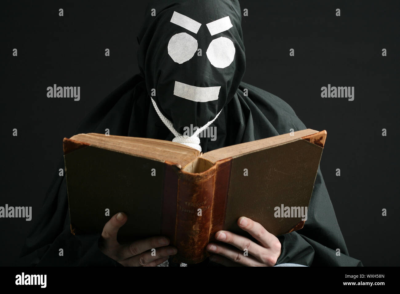 Black mime with rope on neck on black background Stock Photo - Alamy