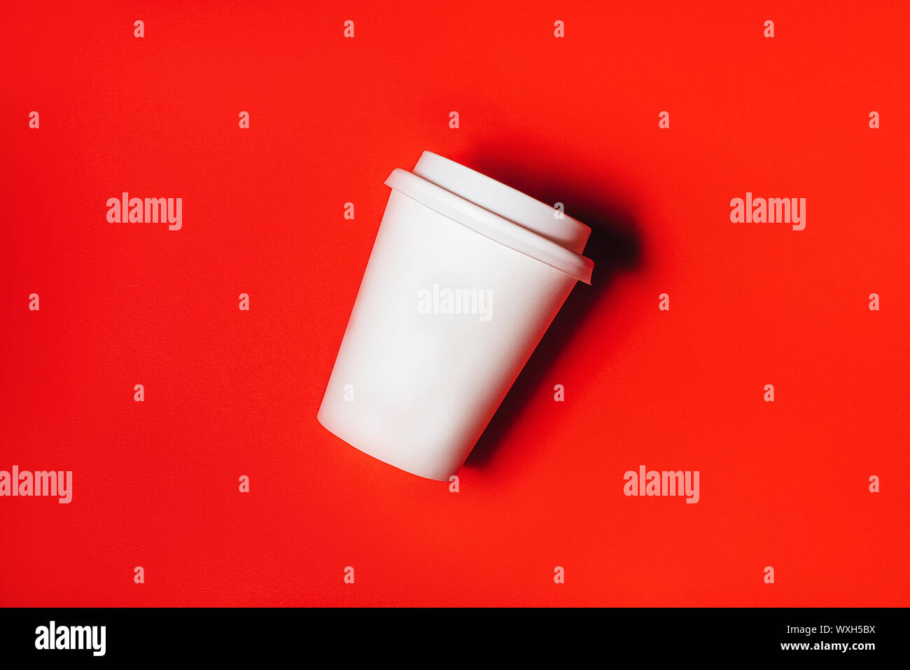 One paper cup on red background Stock Photo - Alamy