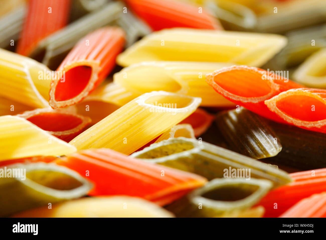 Colored dry italian pasta background Stock Photo - Alamy