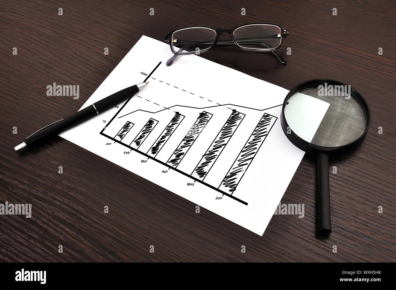 workplace with growth chart on paper Stock Photo - Alamy