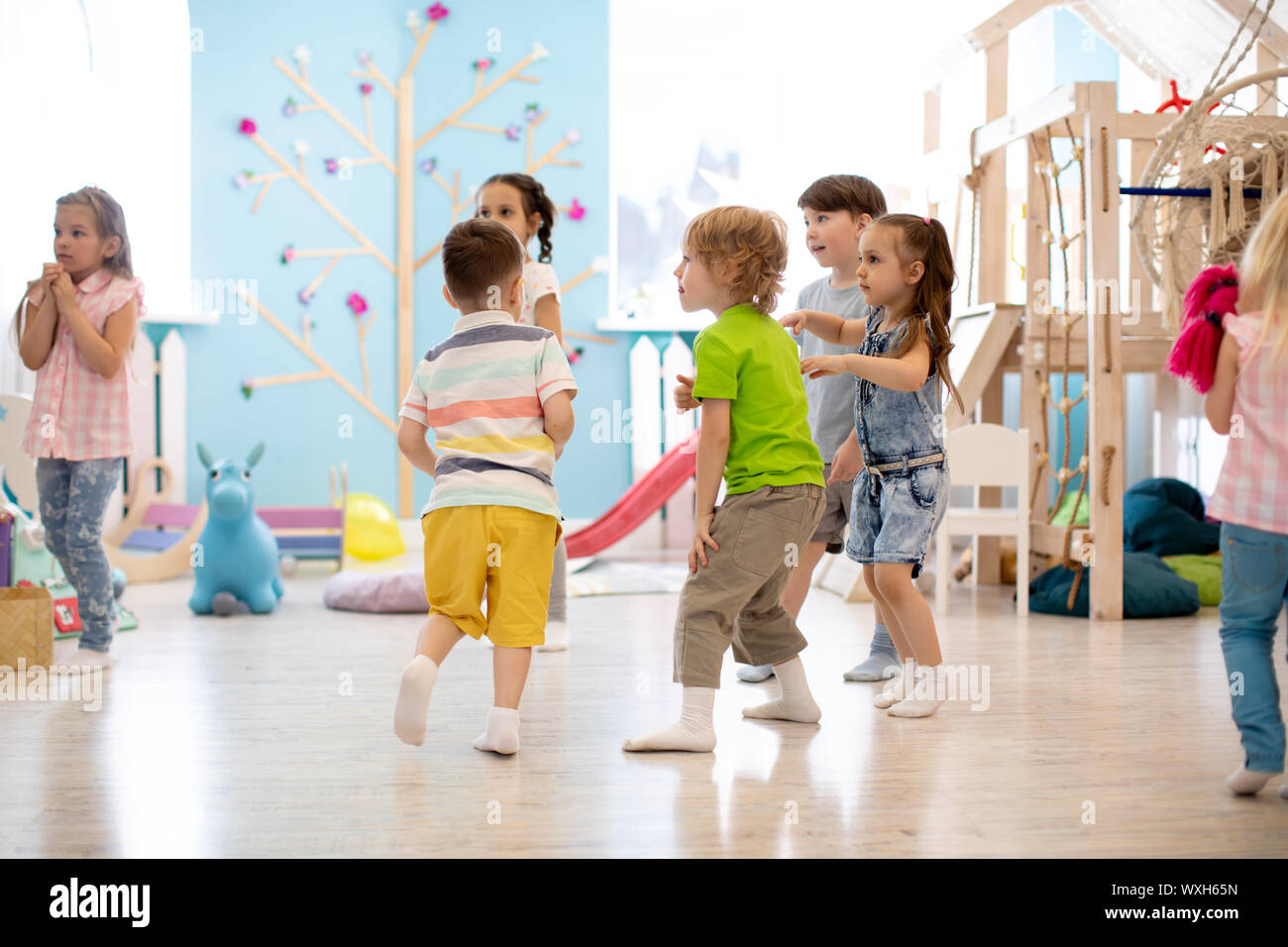 Preschool children run, play educational games in kindergarten or ...