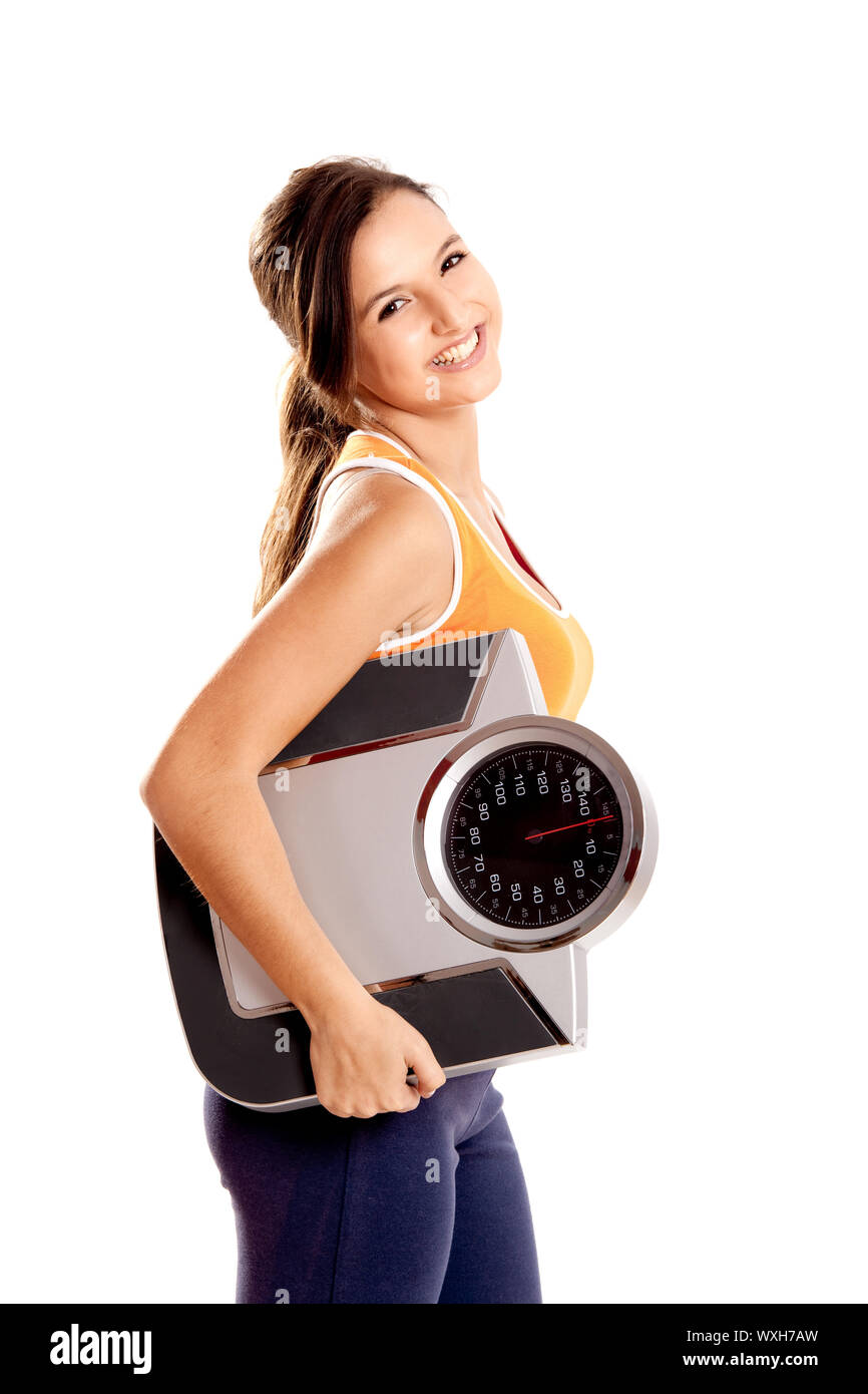 Portrait of a beautiful athletic girl holding a scale, isolated on ...