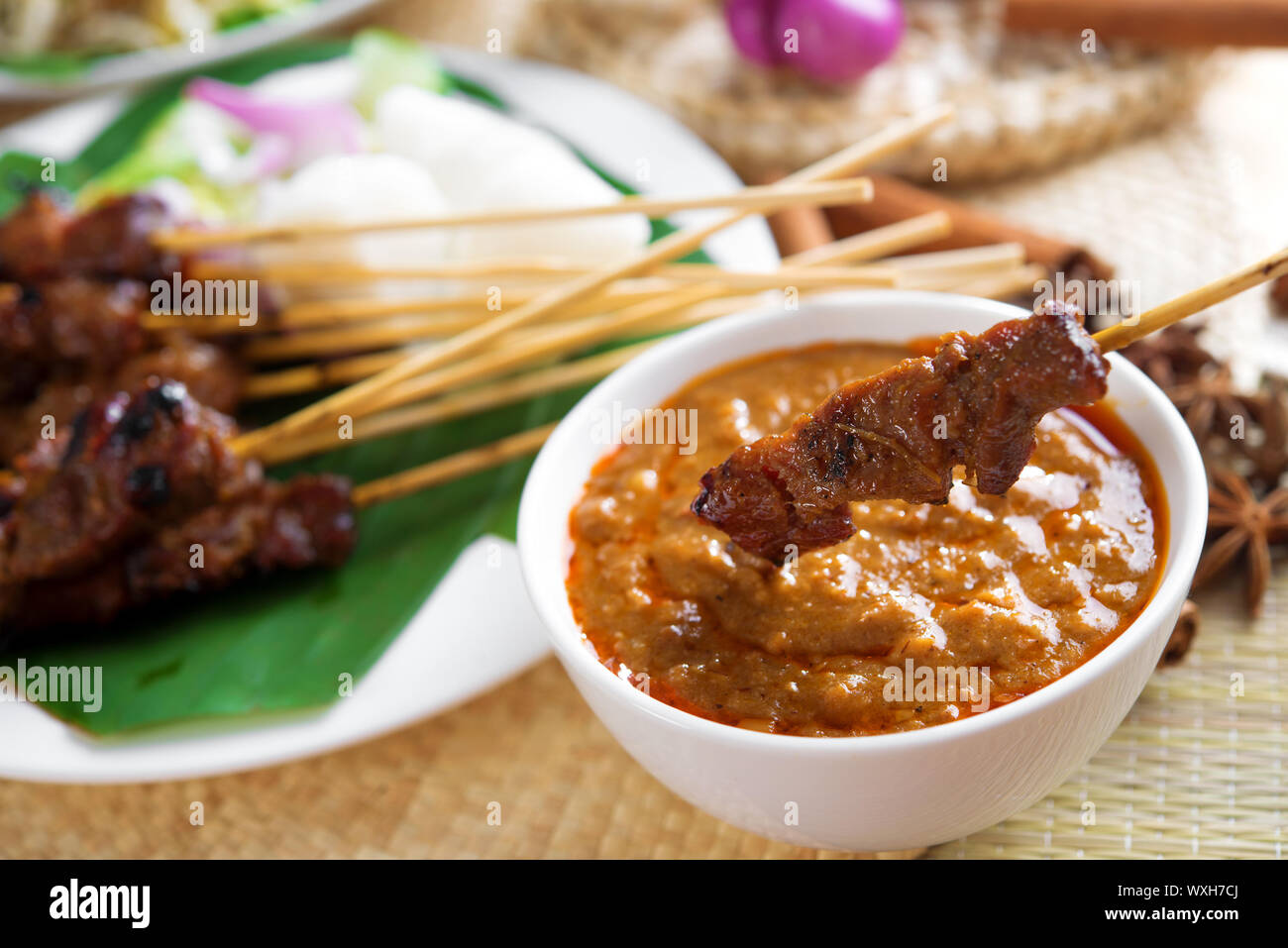 Satay or sate, skewered and grilled meat, served with peanut sauce ...