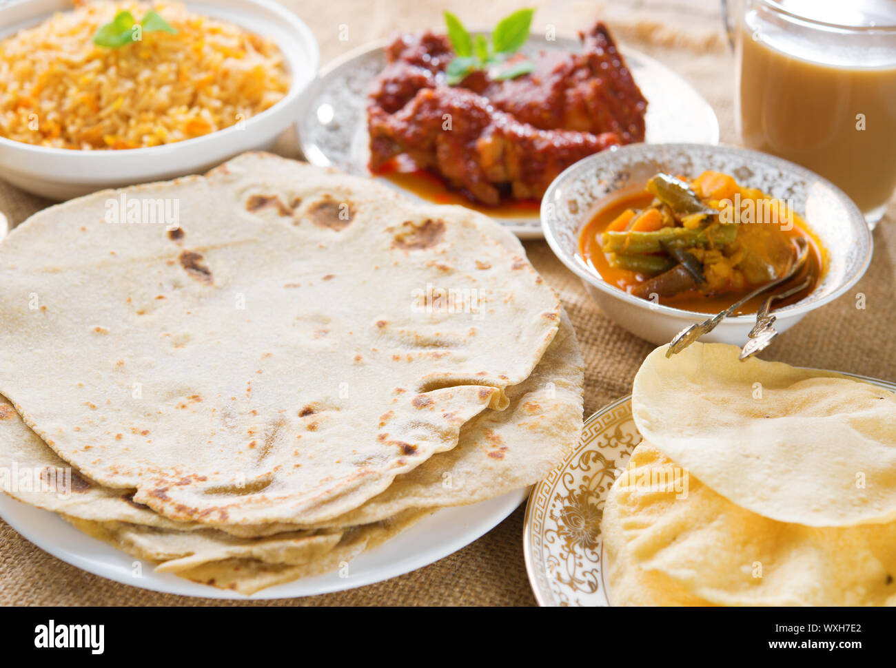Chapatti roti or Flat bread, curry chicken, biryani rice, salad, masala ...
