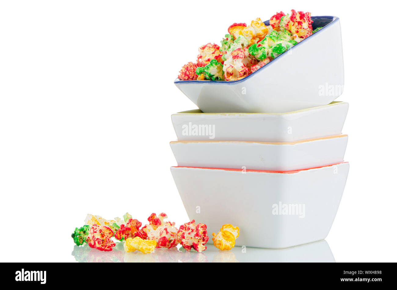 Pile of ceramic bowls of popcorn on white reflective background Stock ...