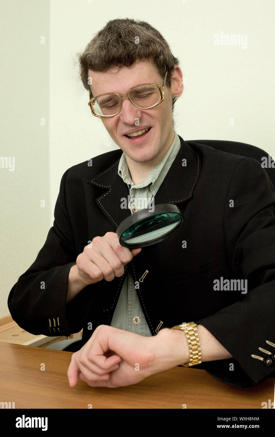 Person examines a watch through a magnifier Stock Photo - Alamy