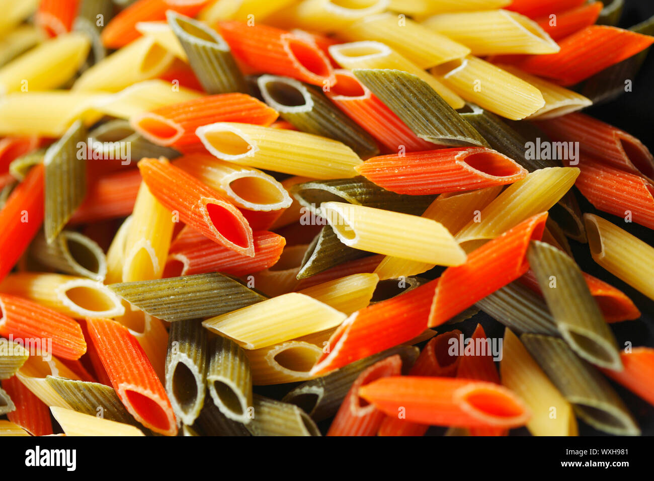 Colored dry italian pasta background Stock Photo - Alamy