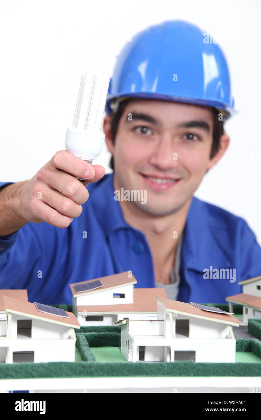 Man stood with energy saving light bulb Stock Photo - Alamy