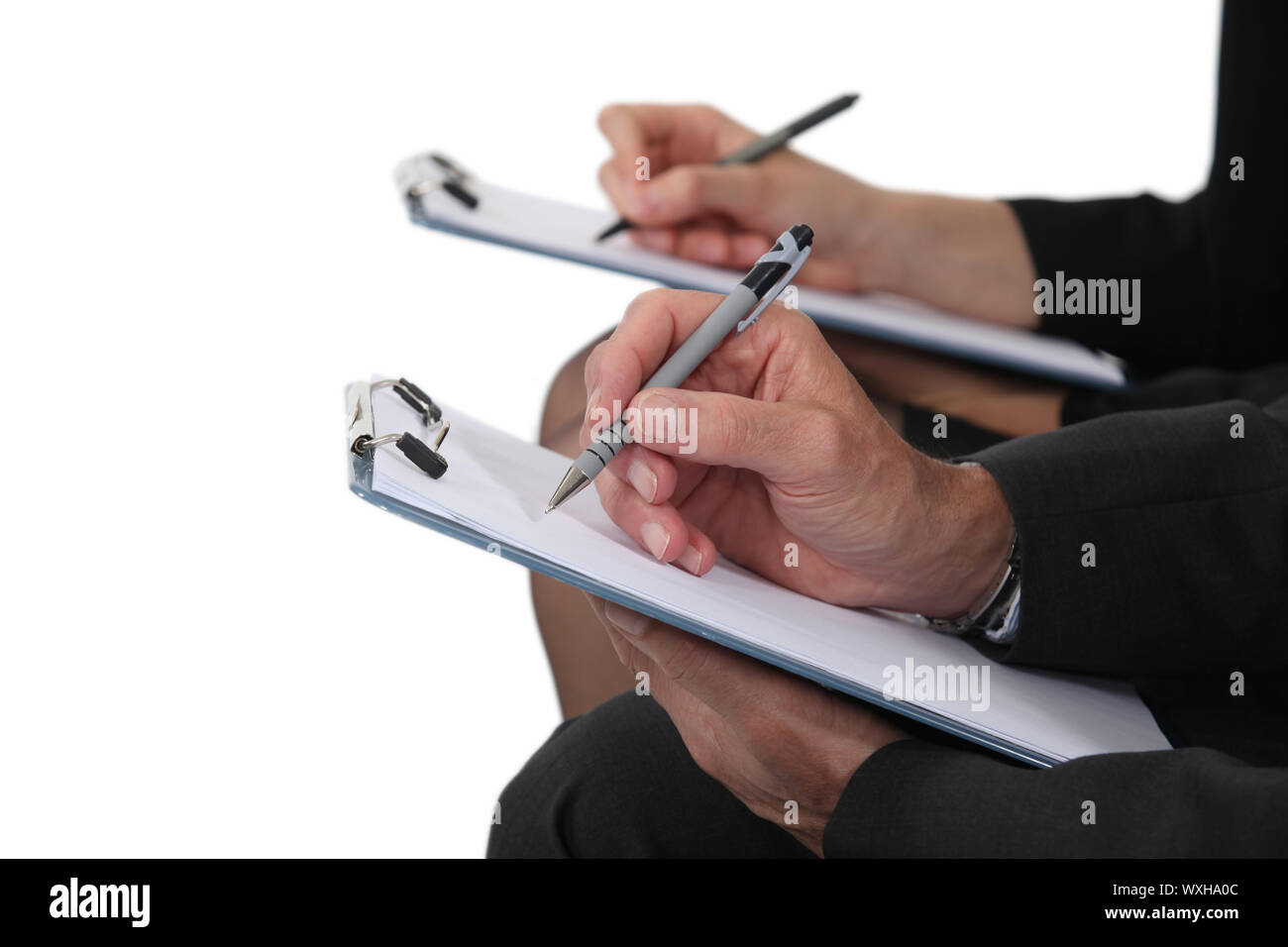 Two businesspeople with clipboards Stock Photo - Alamy