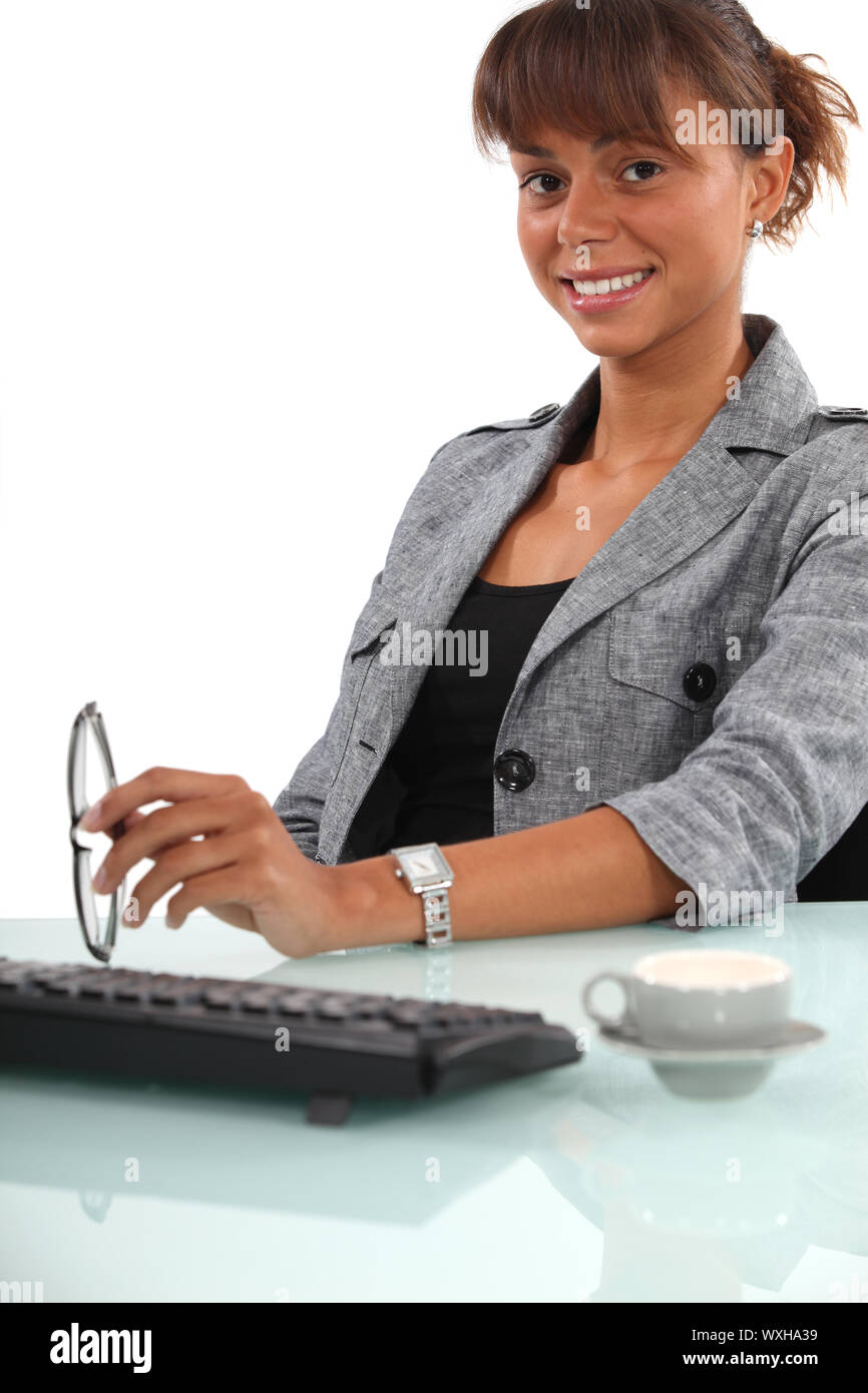 Female office worker at desk Stock Photo - Alamy