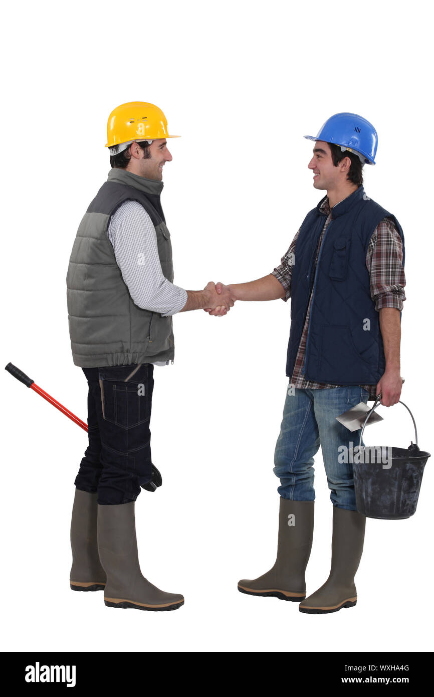 Construction workers shaking hands Stock Photo - Alamy