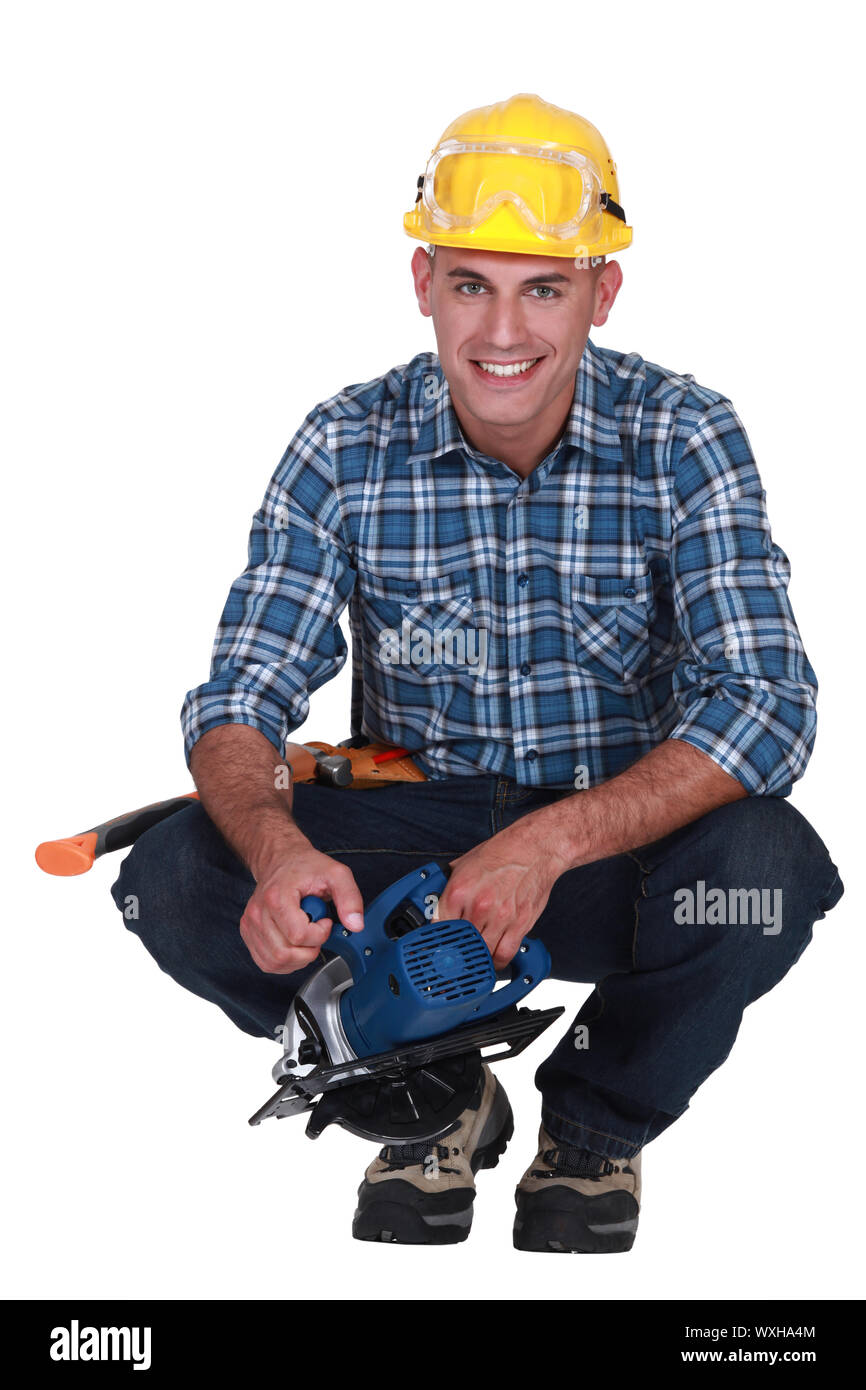 Smiling man with a circular saw Stock Photo - Alamy