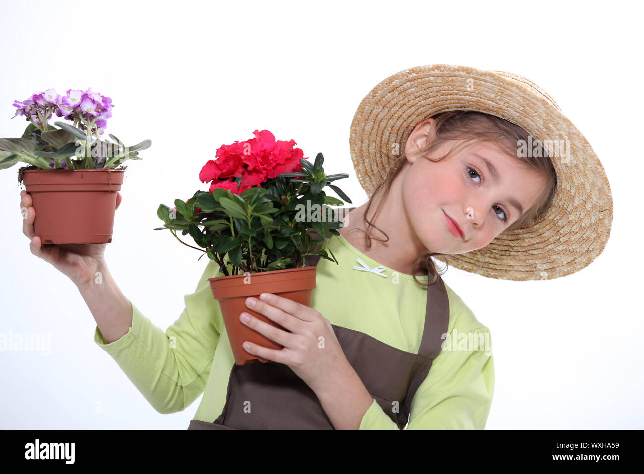 9 years old girl dressed in horticulturist taking flower pots Stock ... 9 years old girl dressed in horticulturist taking flower pots Stock ...