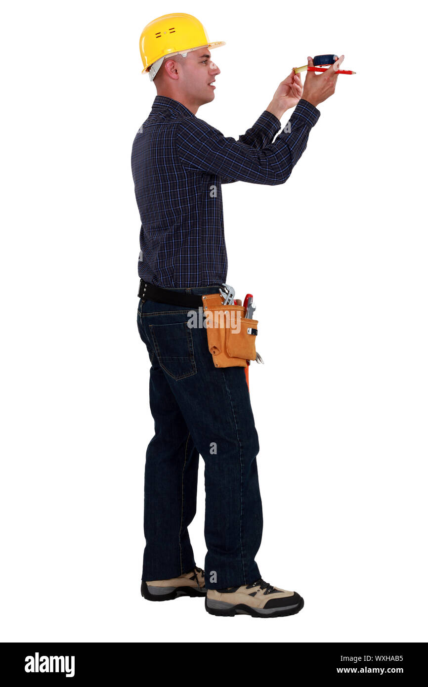 A male construction worker taking measures Stock Photo - Alamy
