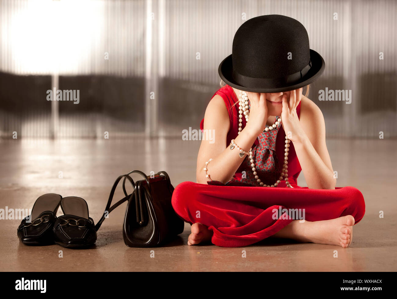 Young girl with her face hidden in her hat Stock Photo - Alamy