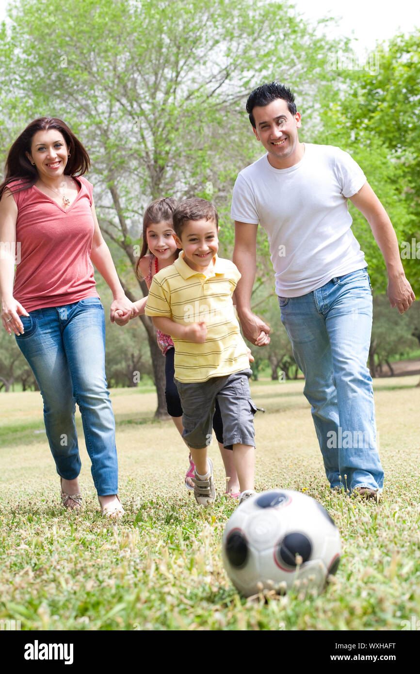 Family outdoor playing soccer and having fun Stock Photo - Alamy