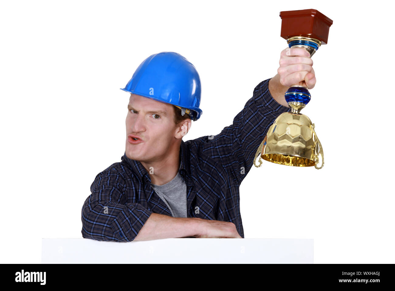 Builder holding trophy Stock Photo - Alamy