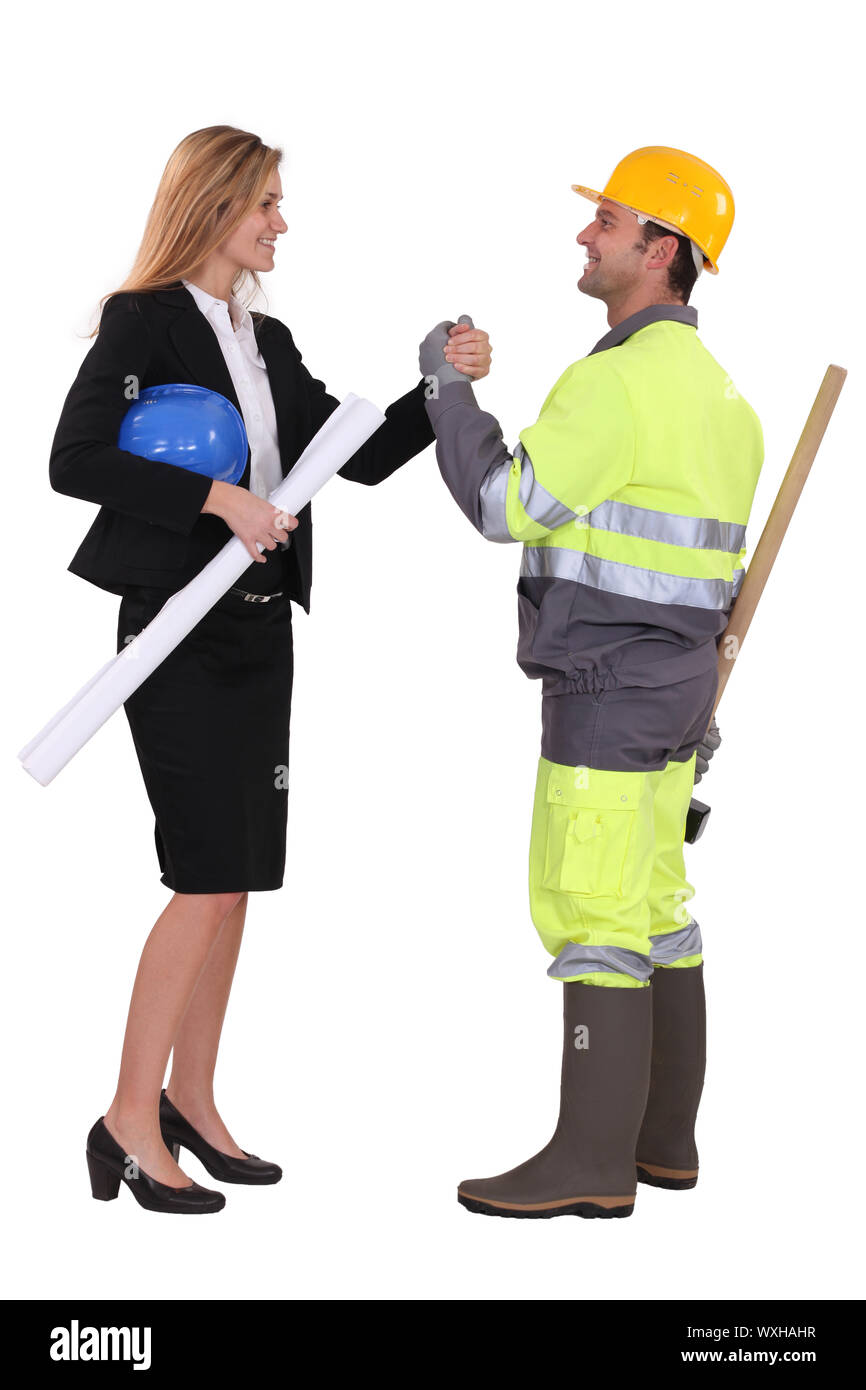 Project workers greeting each other Stock Photo - Alamy
