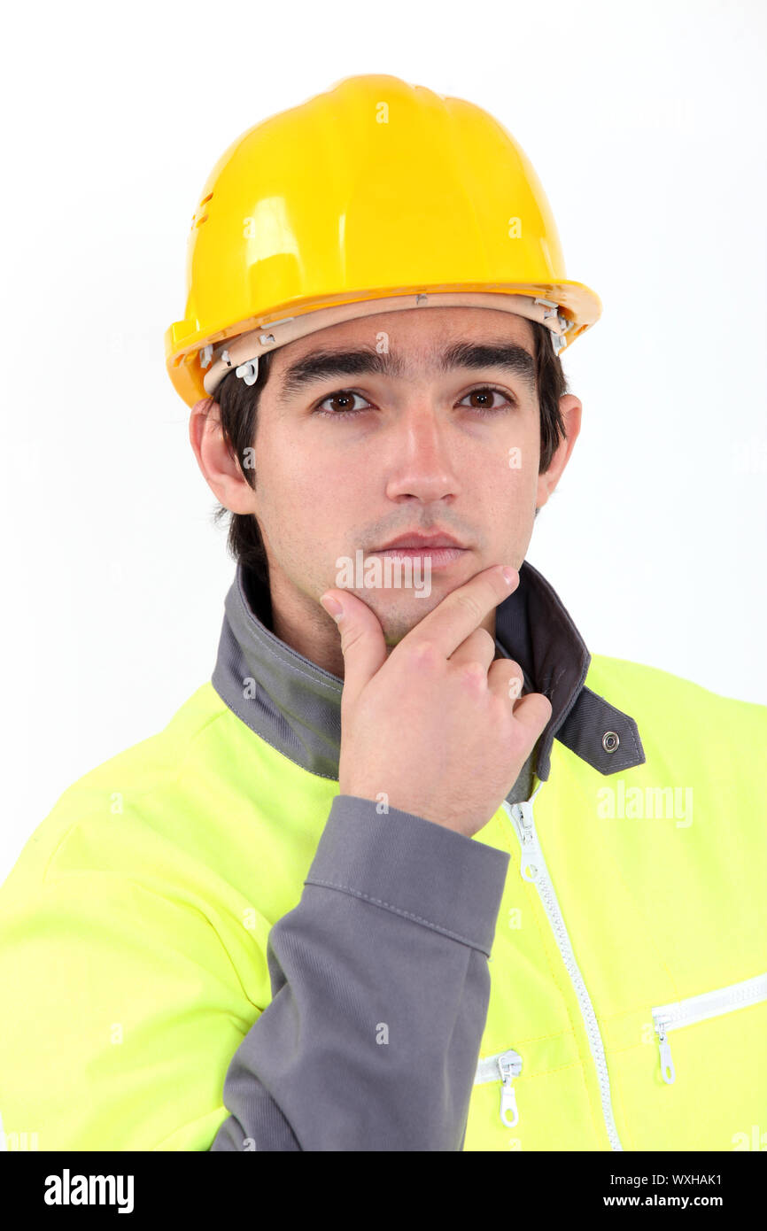 worker holding his chin Stock Photo - Alamy