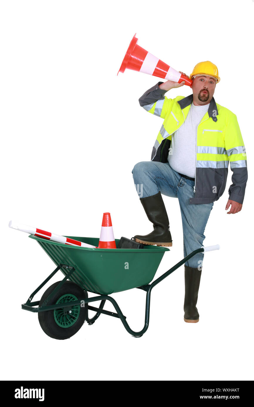 Worker listening through a traffic cone Stock Photo - Alamy