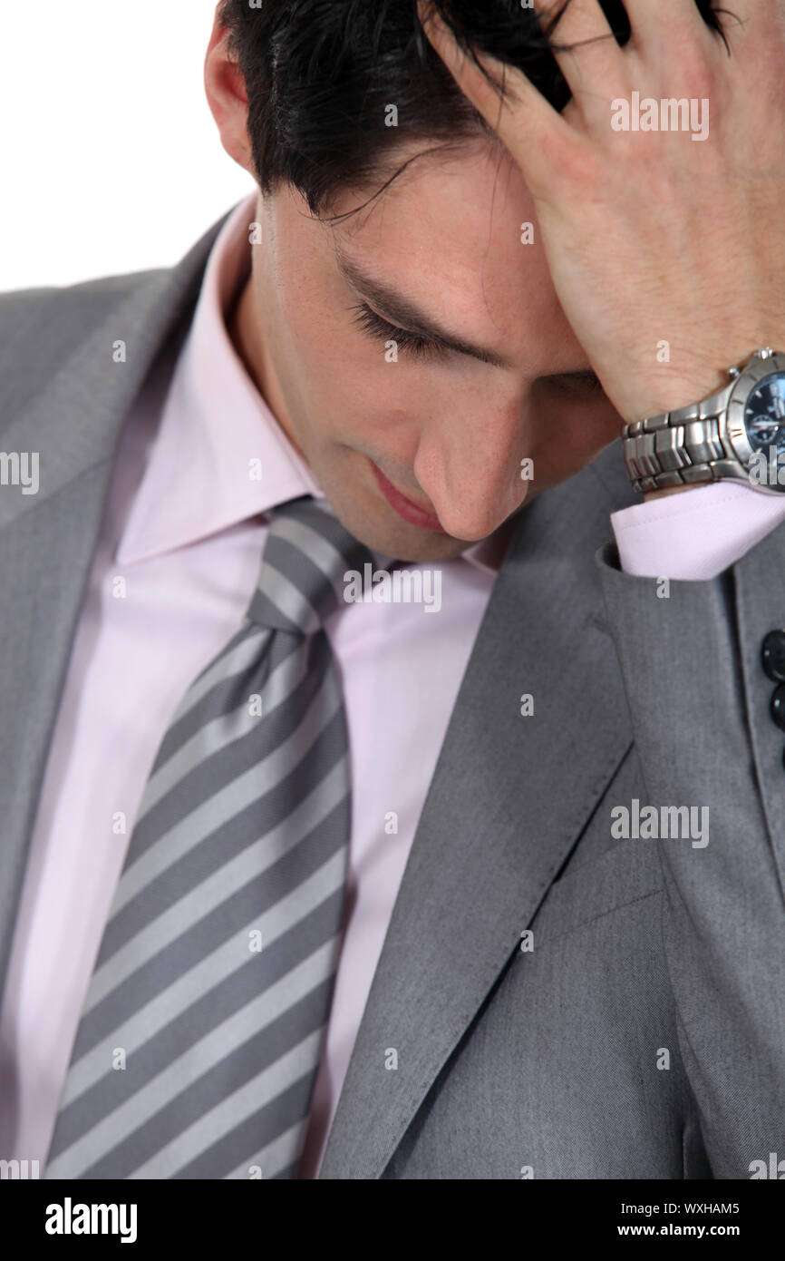Businessman running his fingers through his hair Stock Photo - Alamy