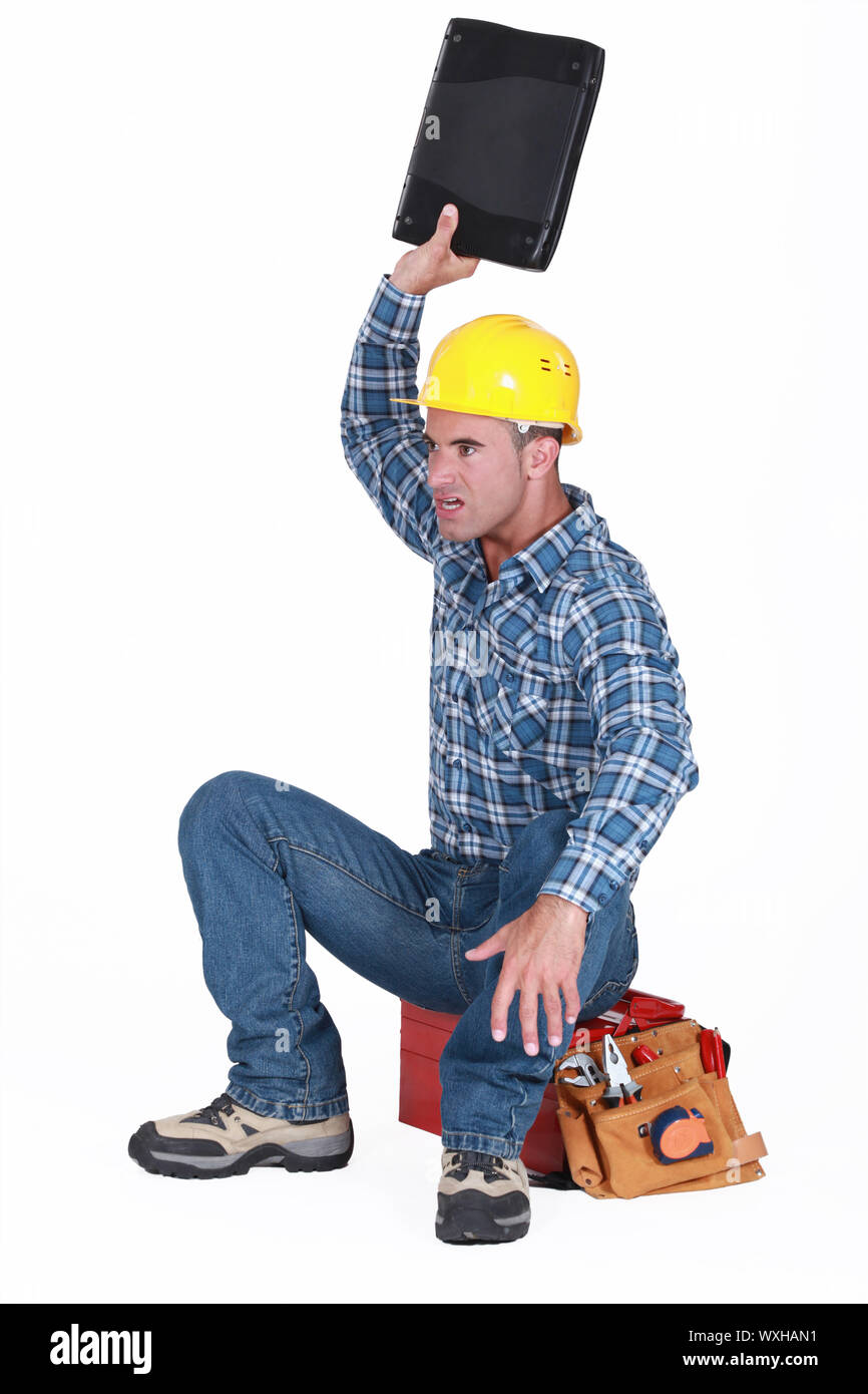 Building inspector angry at broken laptop Stock Photo - Alamy