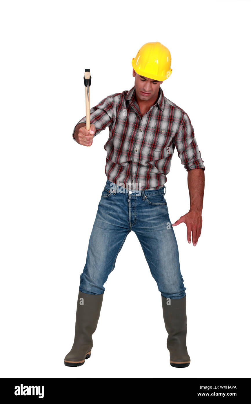 Labourer using a hammer Stock Photo - Alamy