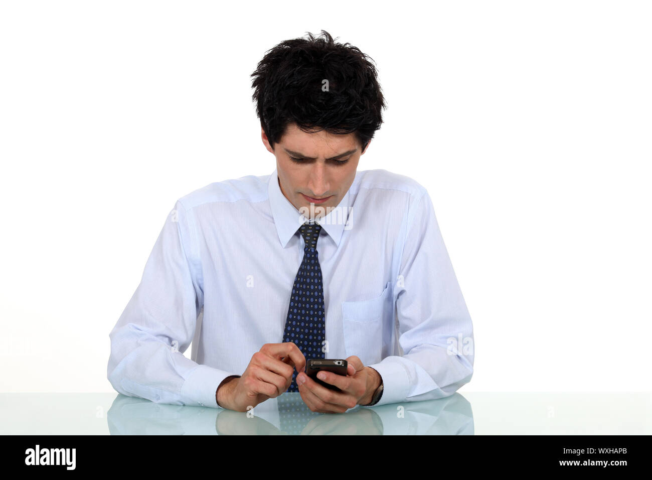 Worried man typing an sms Stock Photo - Alamy