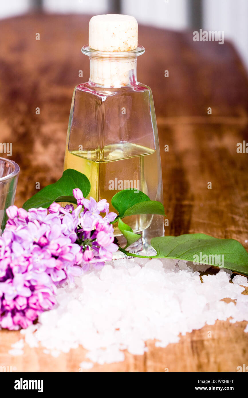 bath and spa items (salt, oil, lilac) on wooden background Stock Photo ...