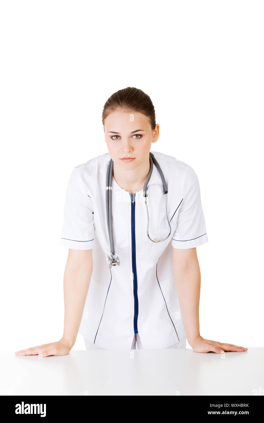 Medical doctor or nurse behind the desk. Isolated over white background ...