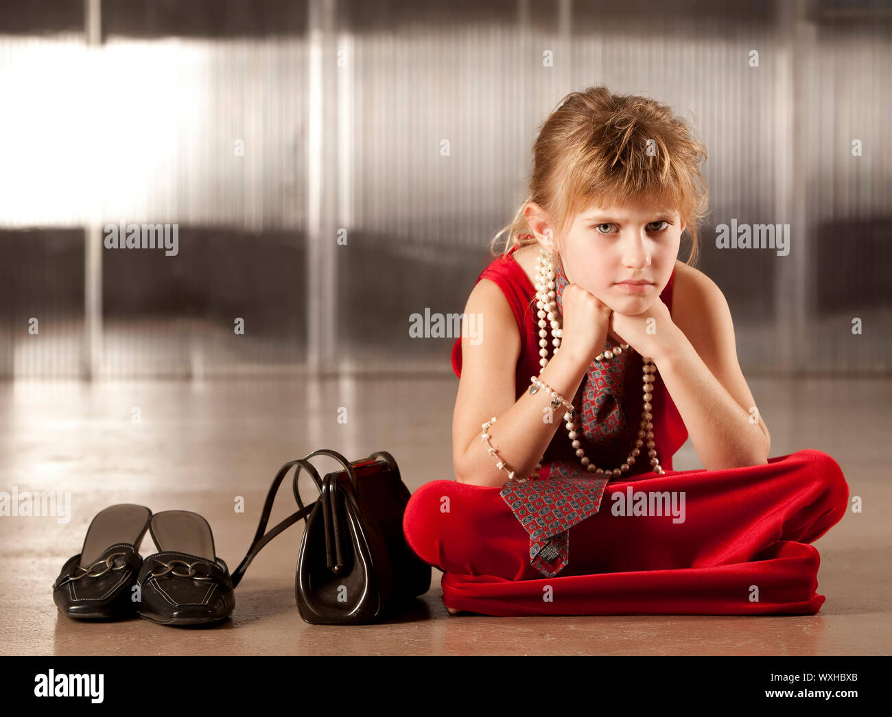 Sullen young girl with big eyes in dress-up clothes Stock Photo - Alamy