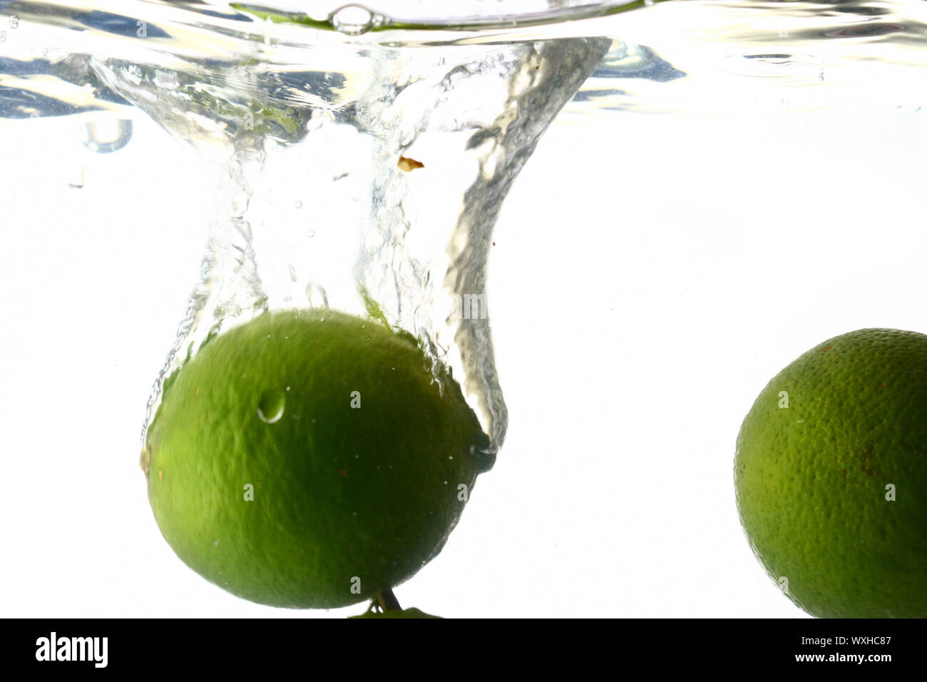 lime splash isolated on white background Stock Photo - Alamy