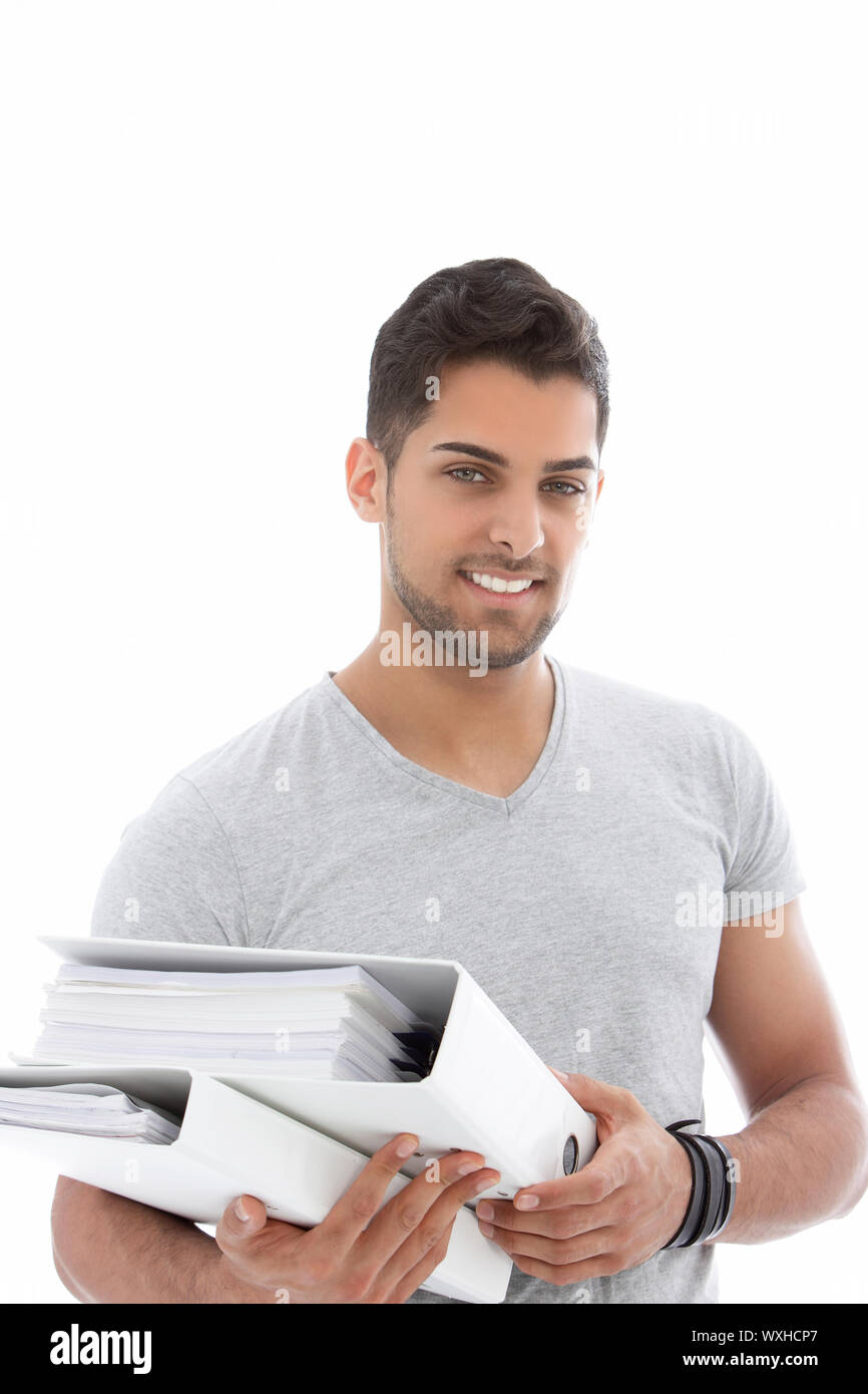 Handsome young man holding a pile of folders against the white ...