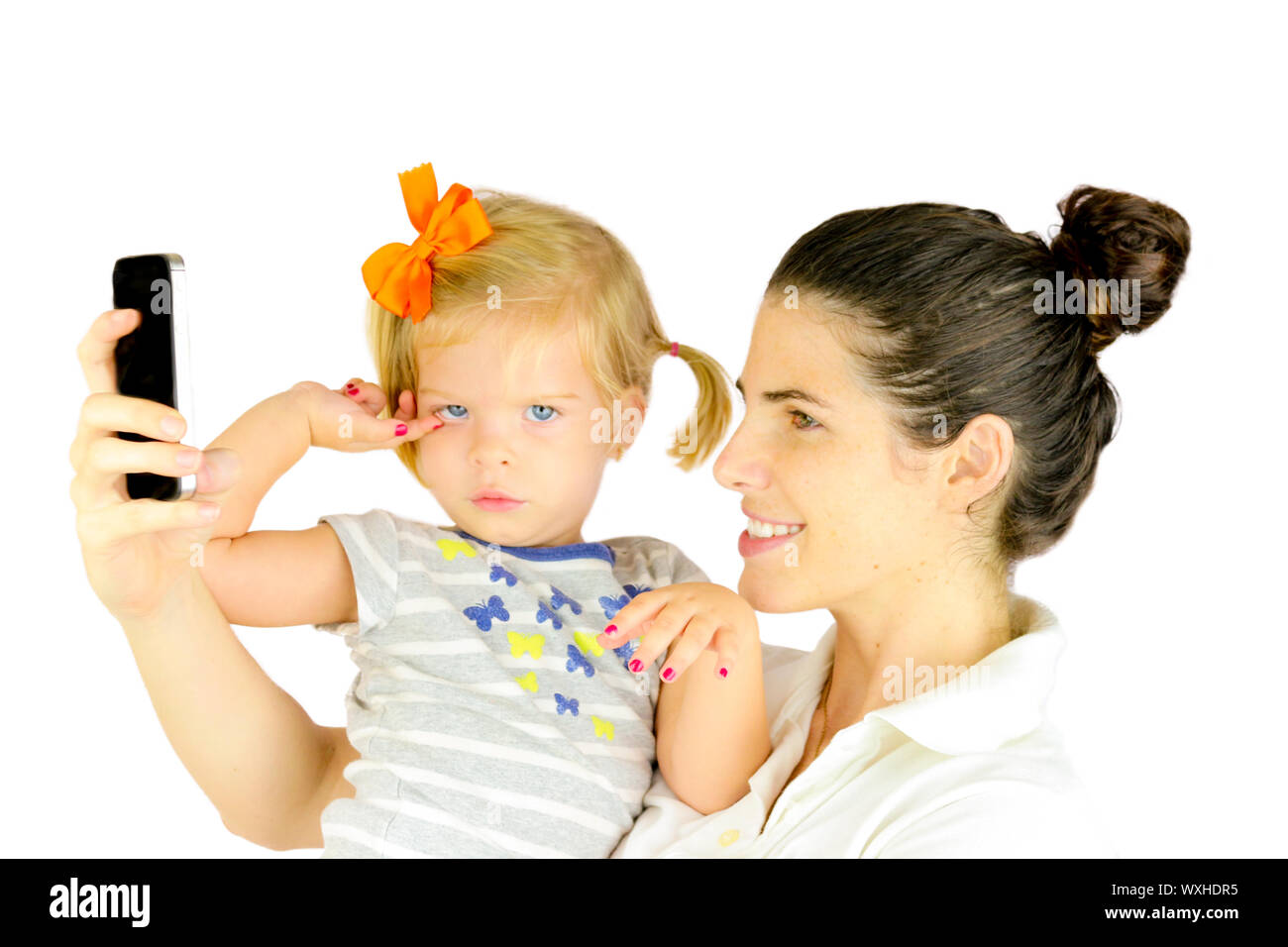 Baby girl bored with too much technology Stock Photo - Alamy