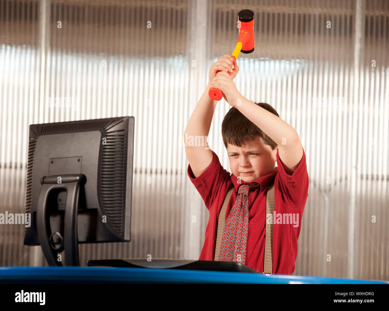 Nerdy young boy smashing his computer with a hammer Stock Photo - Alamy