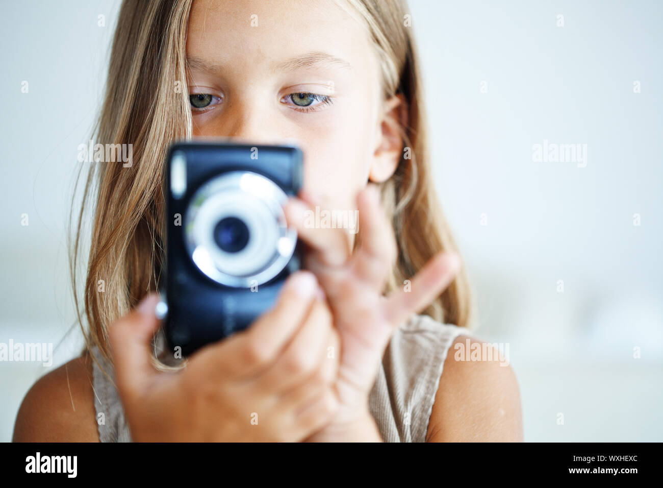 Little girl with compact photo camera Stock Photo - Alamy