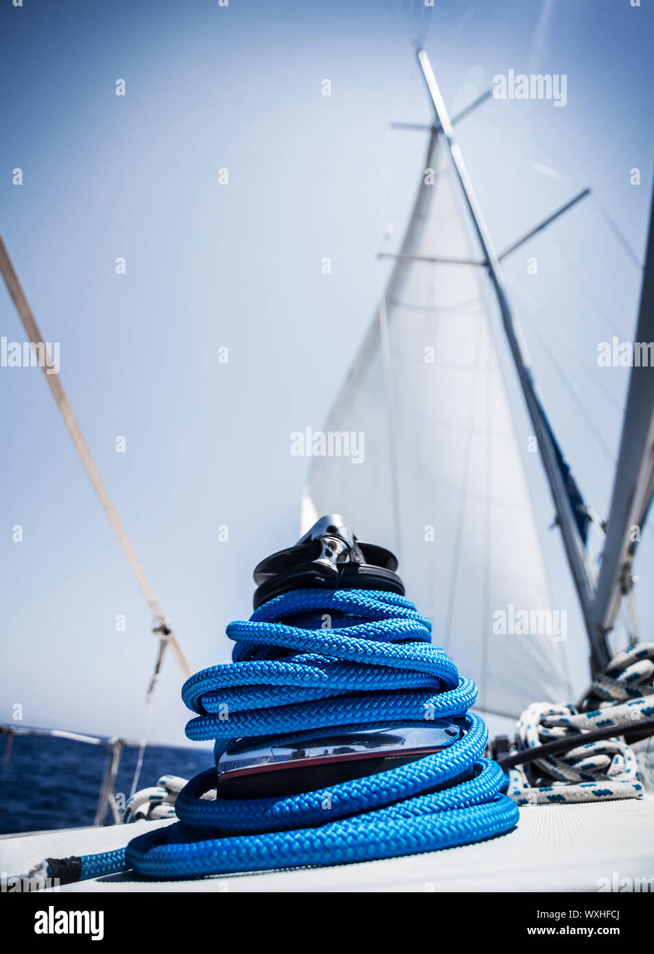 Closeup on yacht cord crank, rope holder on white sail background ...