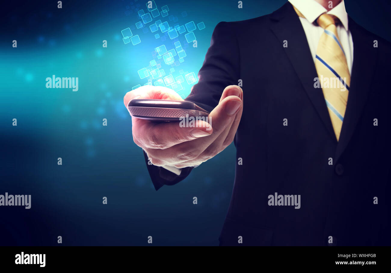 Business man with a mobile phone on a modern technology background ...
