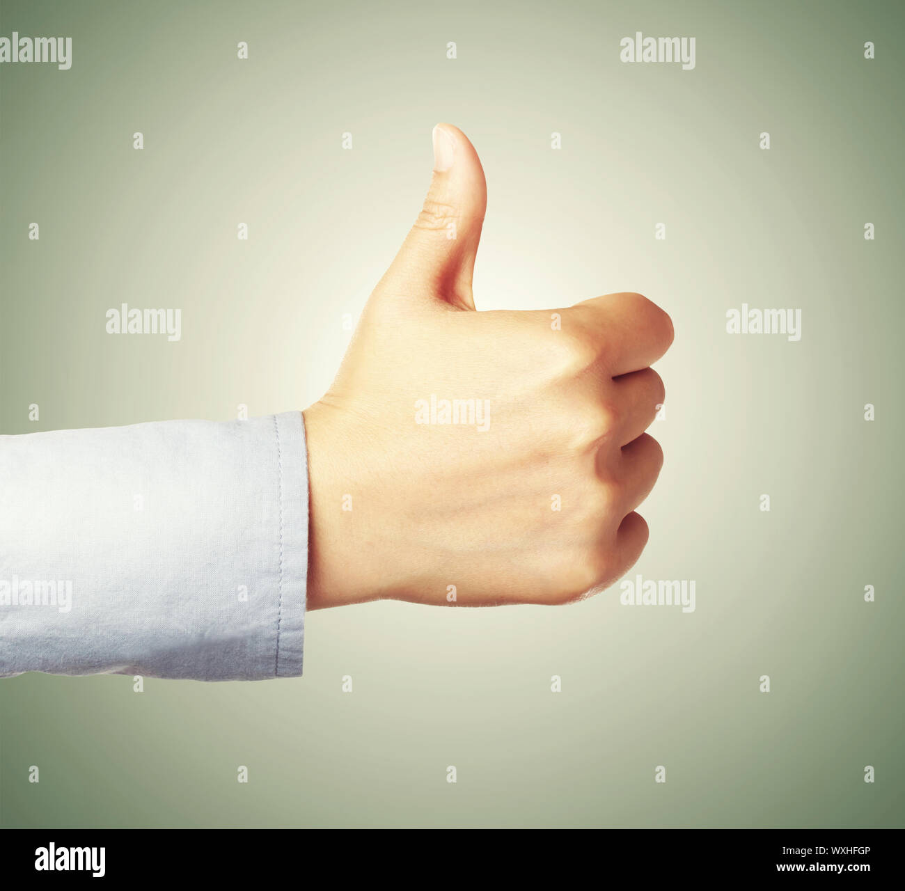 Giving thumbs up or like on green background Stock Photo - Alamy