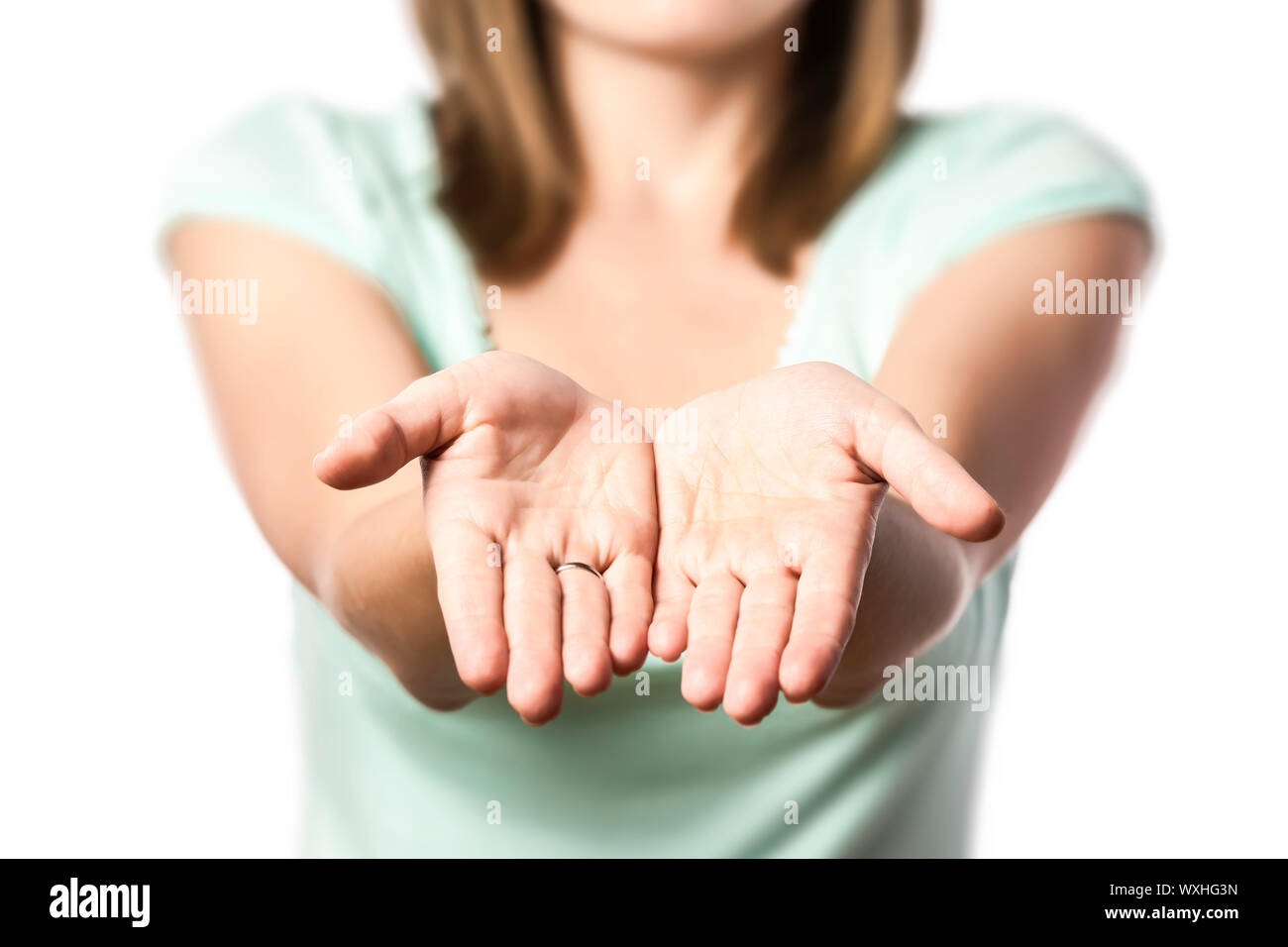 Young woman stretches out her empty hands, isolated on white ...