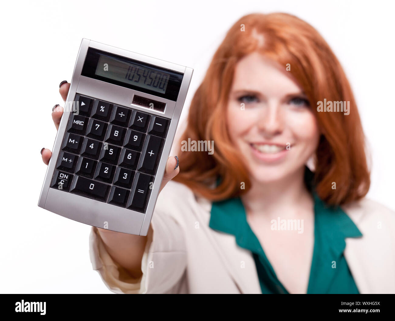 attractive smiling redhead business woman with calculator isolated ...