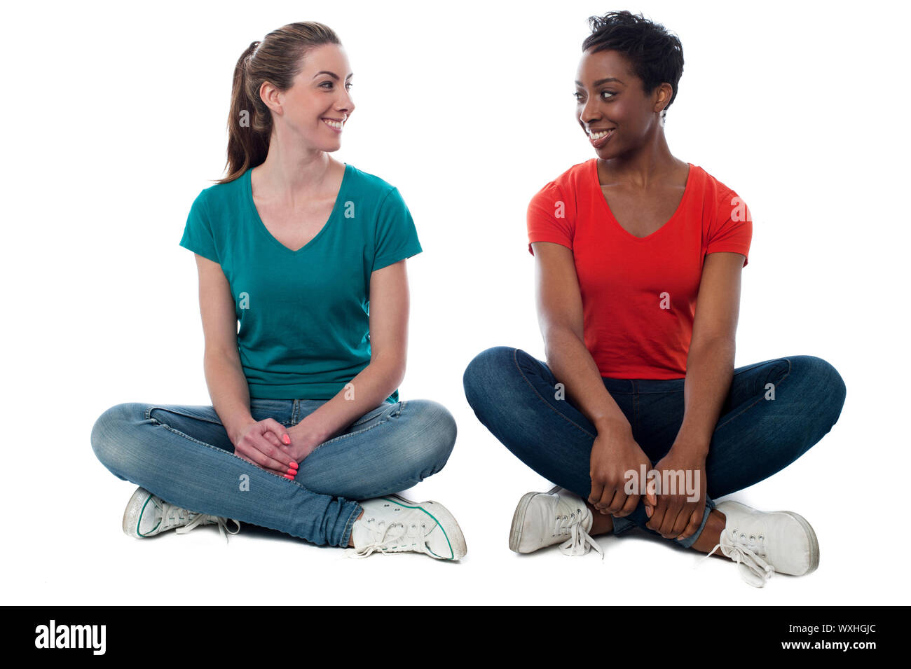 Isolated women sitting on the studio floor Stock Photo - Alamy