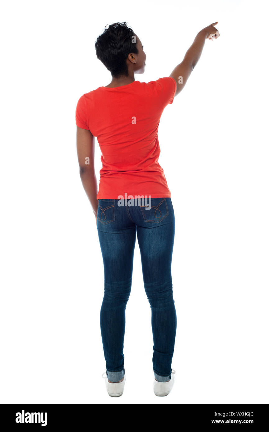 Back pose of a woman pointing at something Stock Photo - Alamy