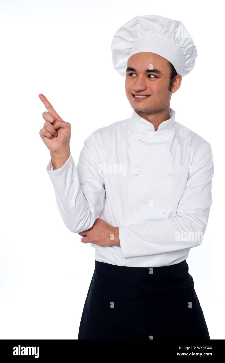 Young male chef pointing at something Stock Photo - Alamy