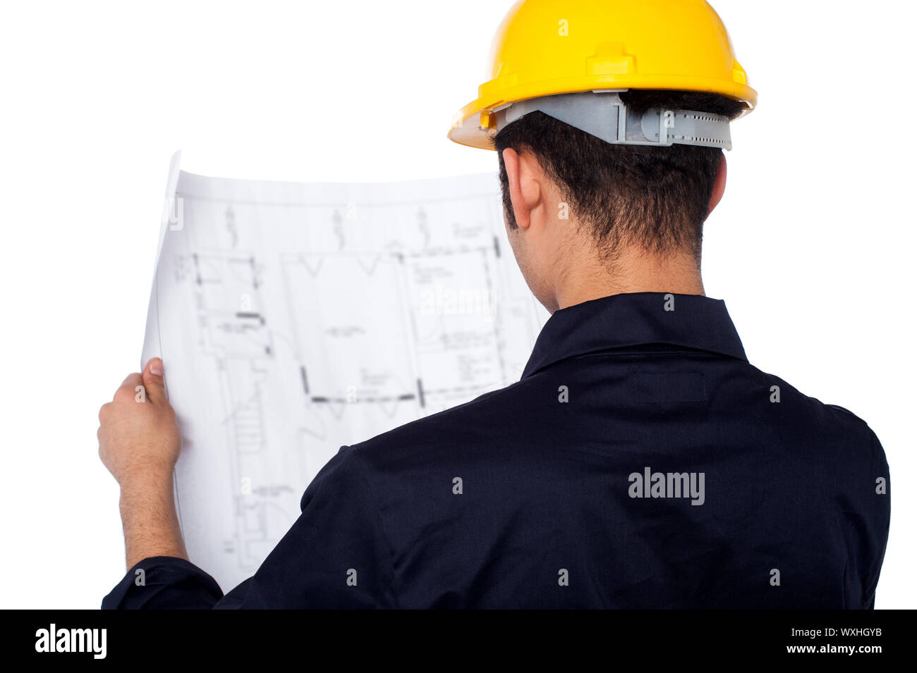 Young male civil engineer with construction plan Stock Photo - Alamy