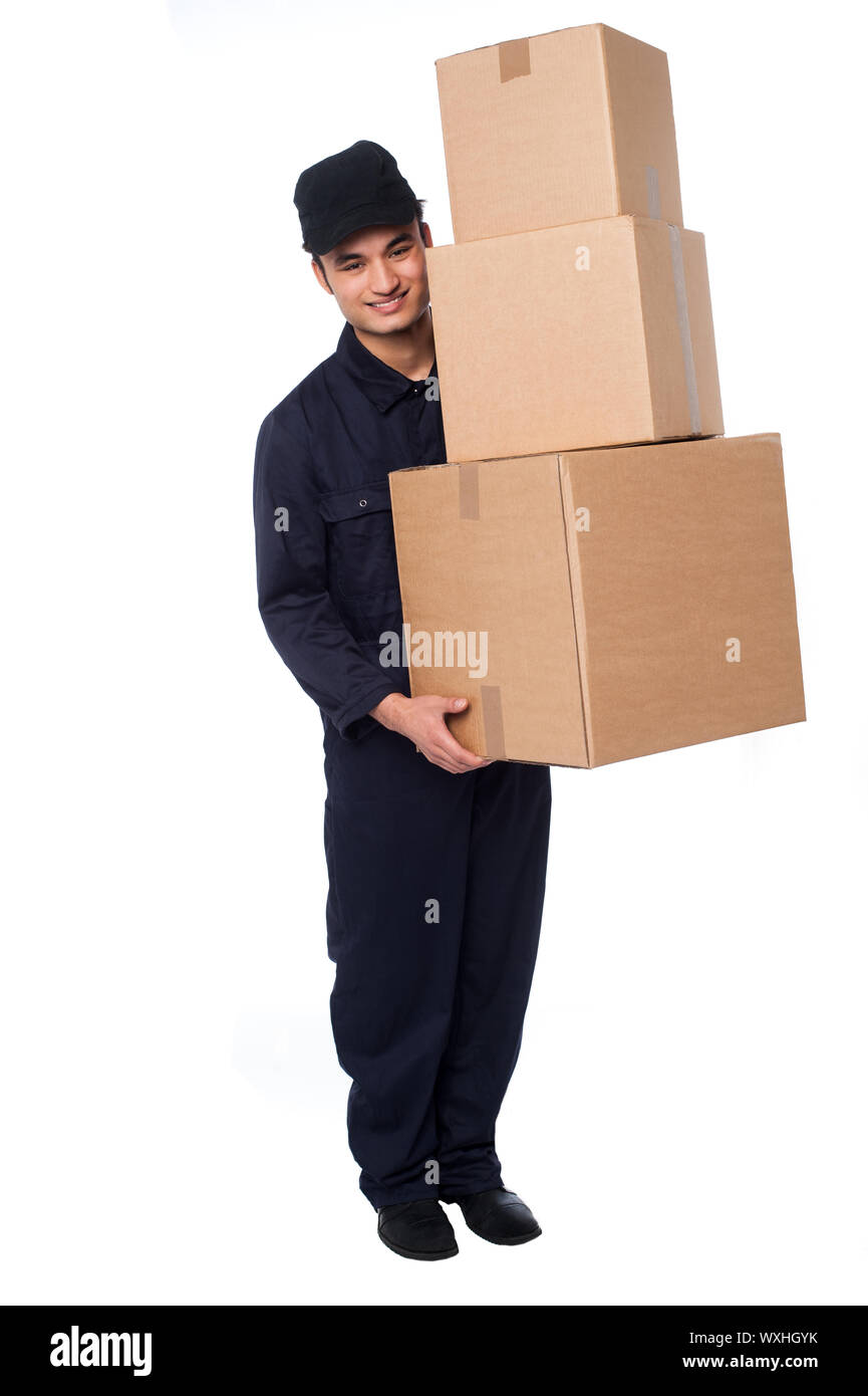 Delivery guy holding stack of parcel boxes Stock Photo - Alamy