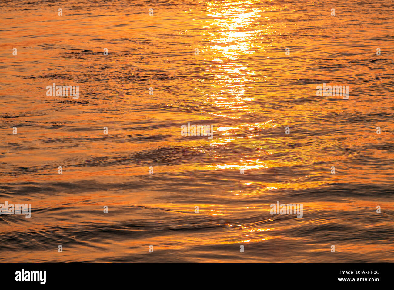 Pattern of water in sunset colours Stock Photo - Alamy